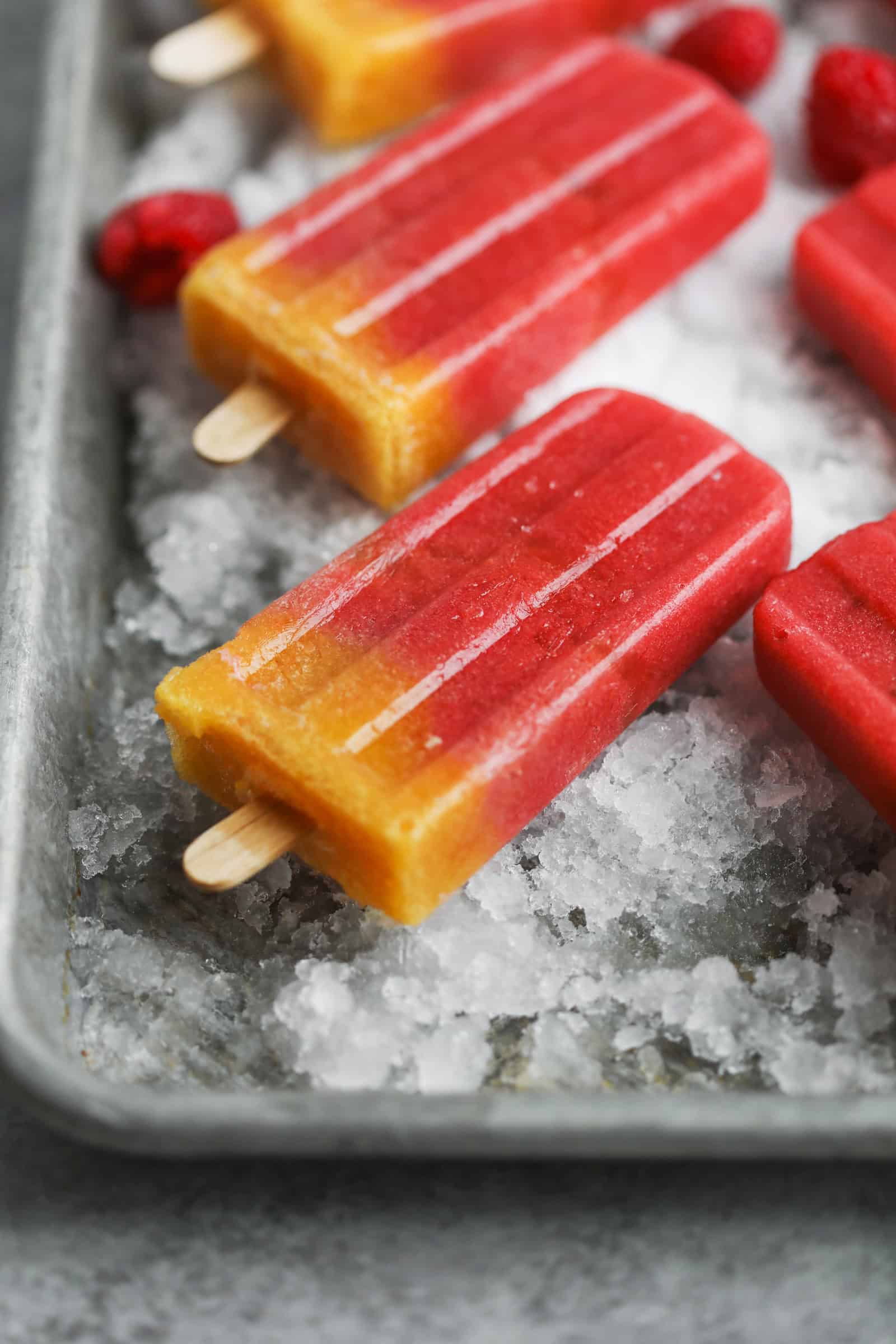 Sunset Orange Raspberry Popsicles - Delish Knowledge